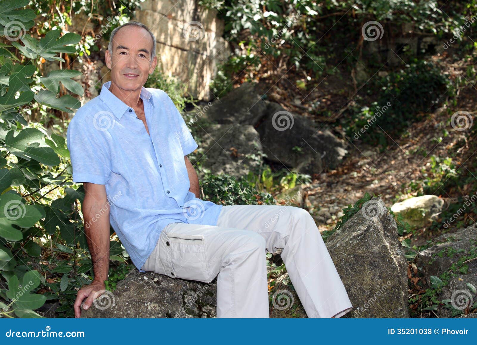 Man sitting in the woods stock photo. Image of person - 35201038
