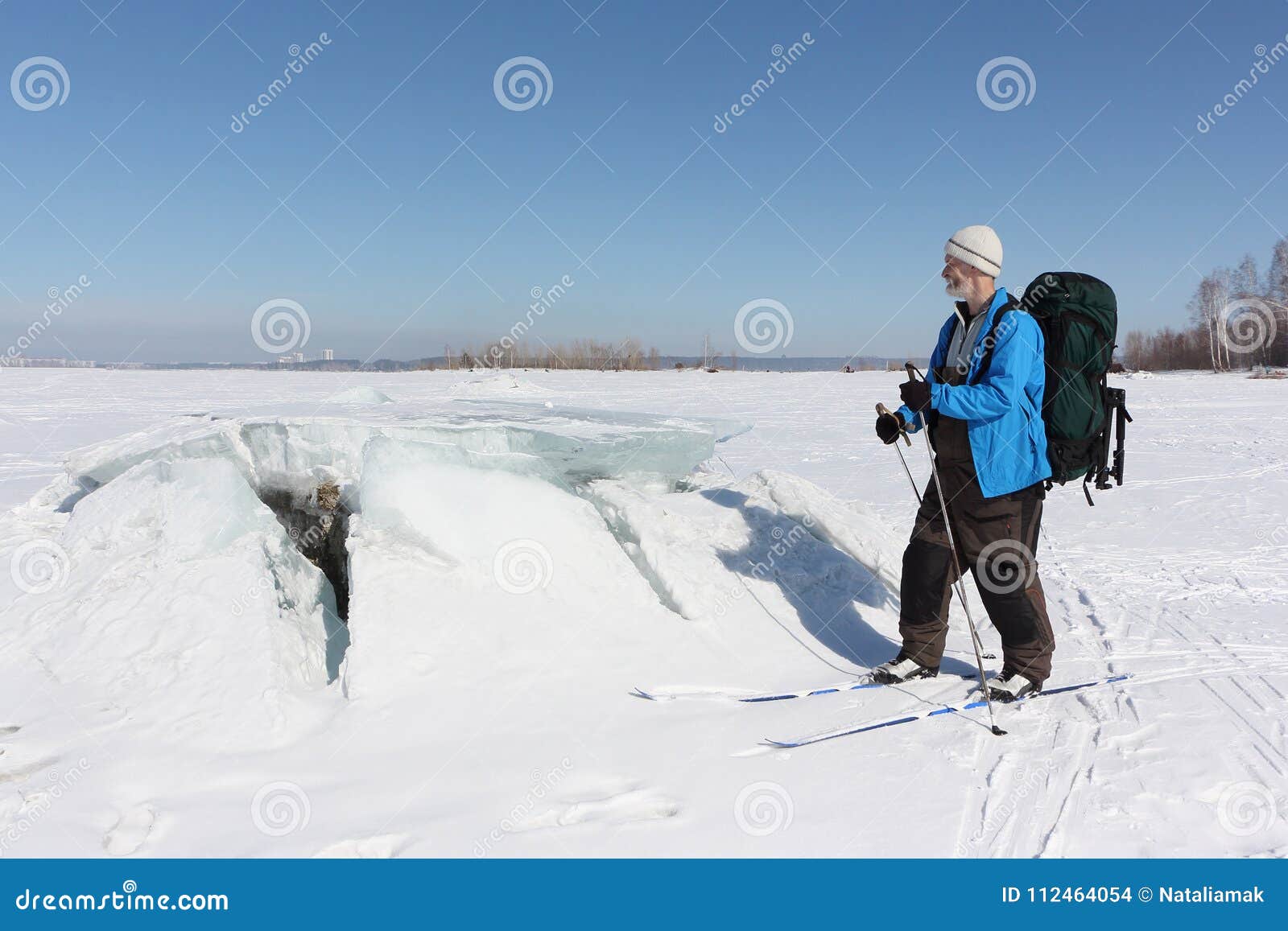Man on Ski Looking at the Ice Breaking on the River Stock Photo - Image ...