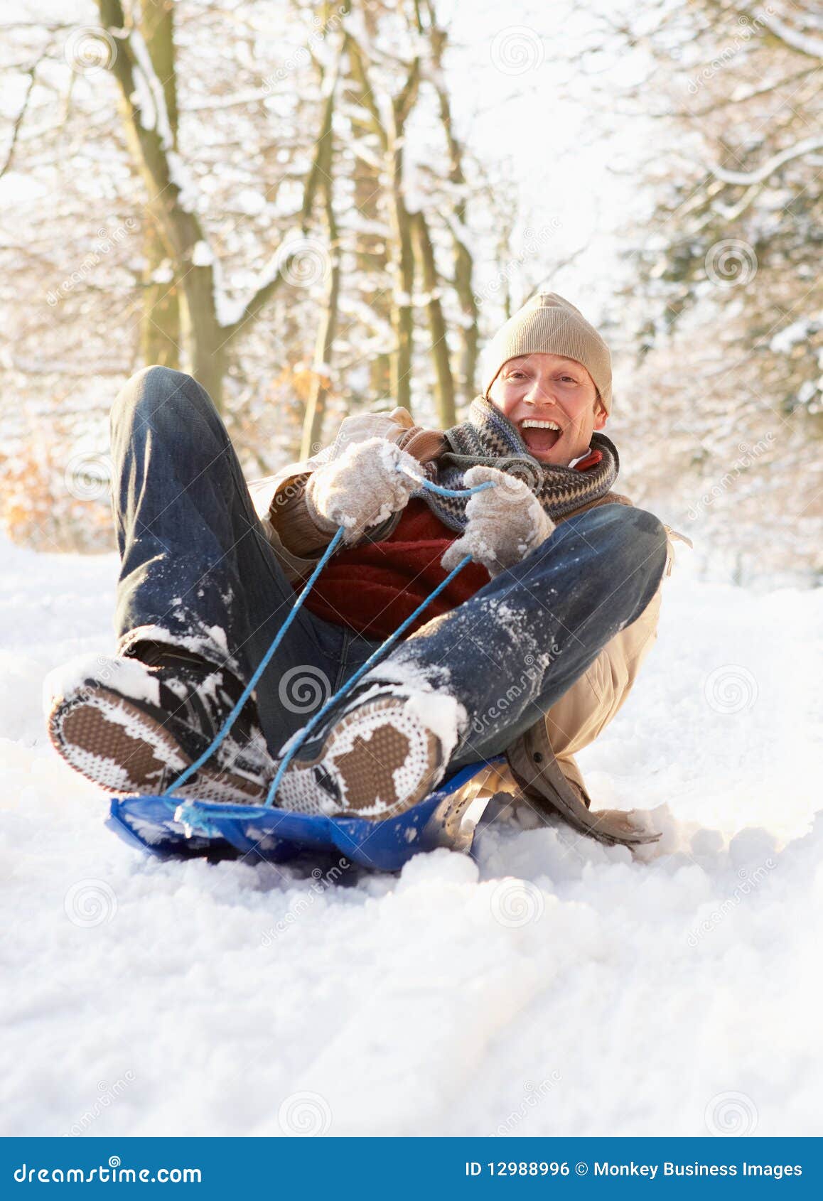 Man Sledging through Snowy Woodland Stock Photo - Image of scarf ...