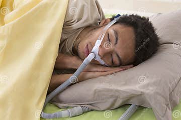 Man with Sleep Apnea Using a CPAP Machine Stock Photo - Image of ...
