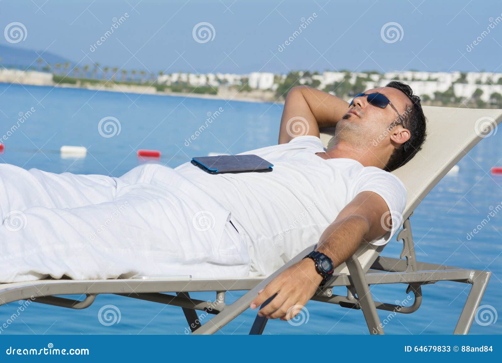 Man sleeping on the beach stock image. Image of laying - 64679833