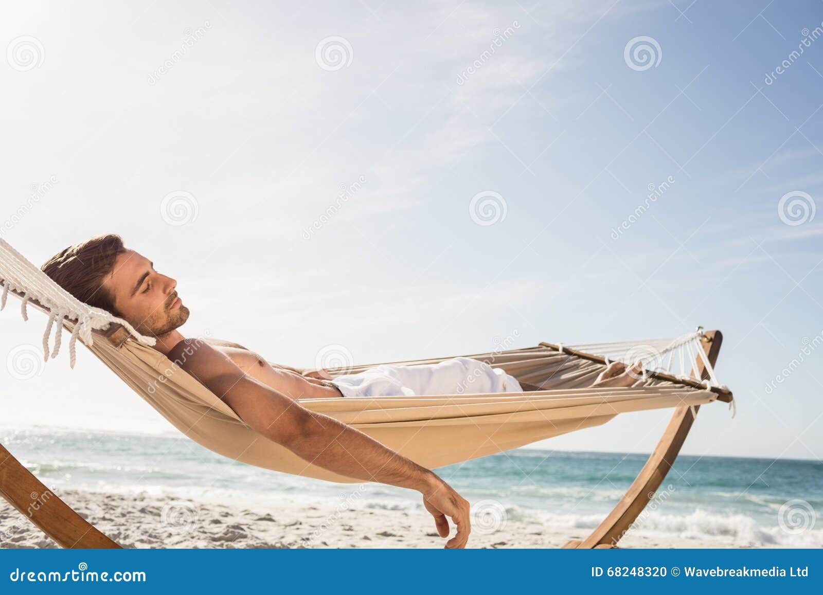 Man sleeping in hammock stock photo. Image of sunbathing - 68248320