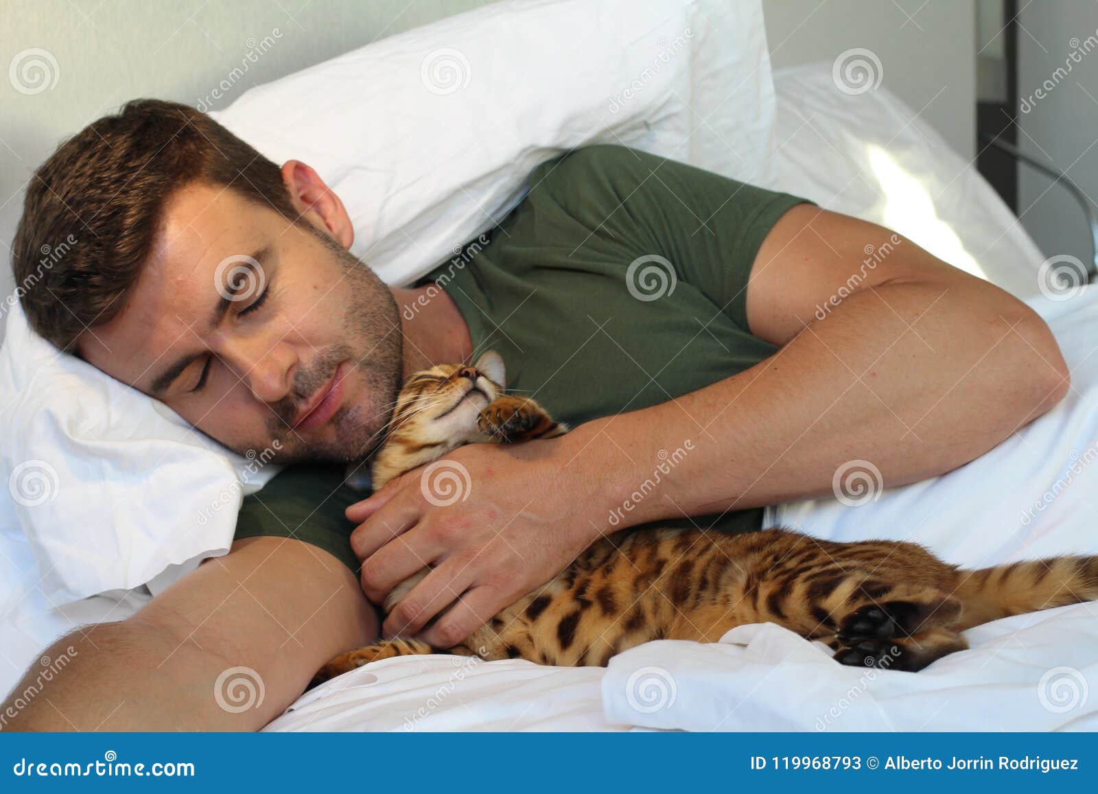 Man And Cat Sleeping On Bed