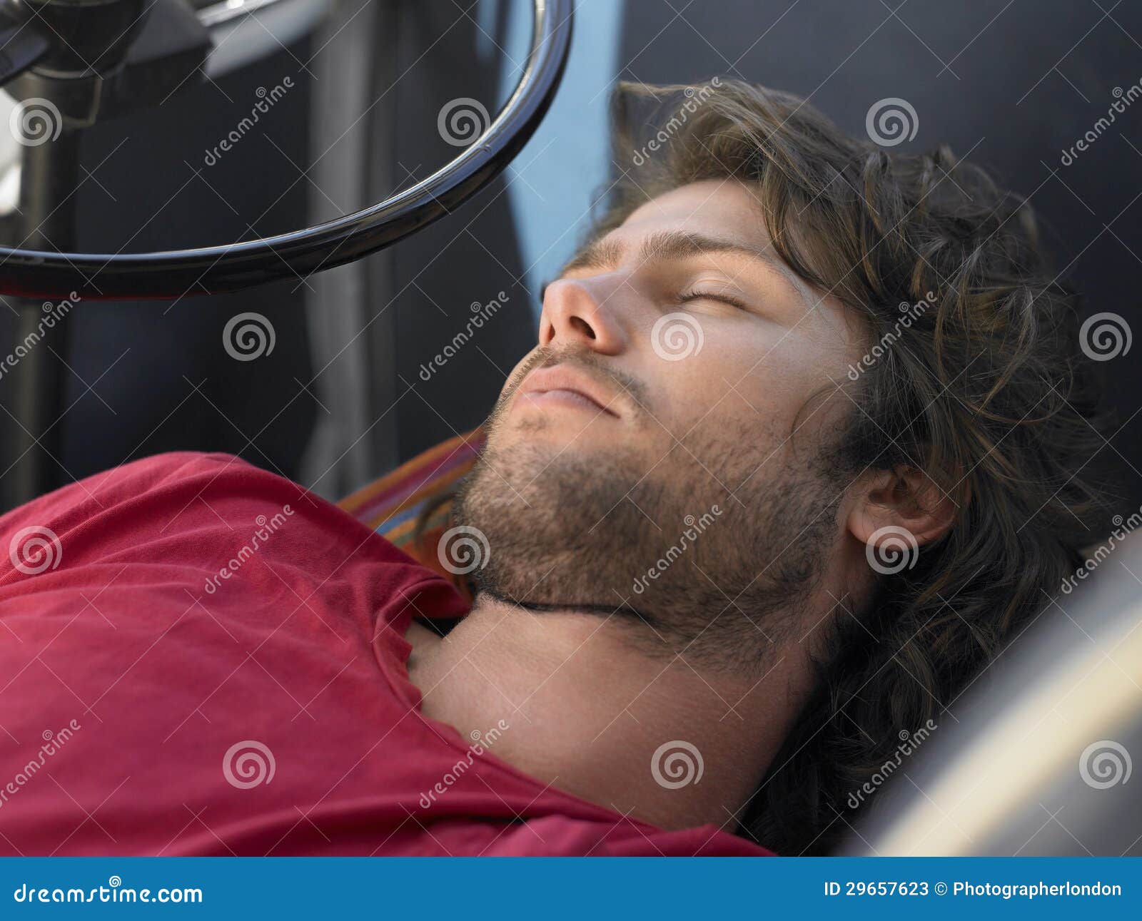 Man Sleeping in Vehicle stock image. Image of curly, headshot - 29657623