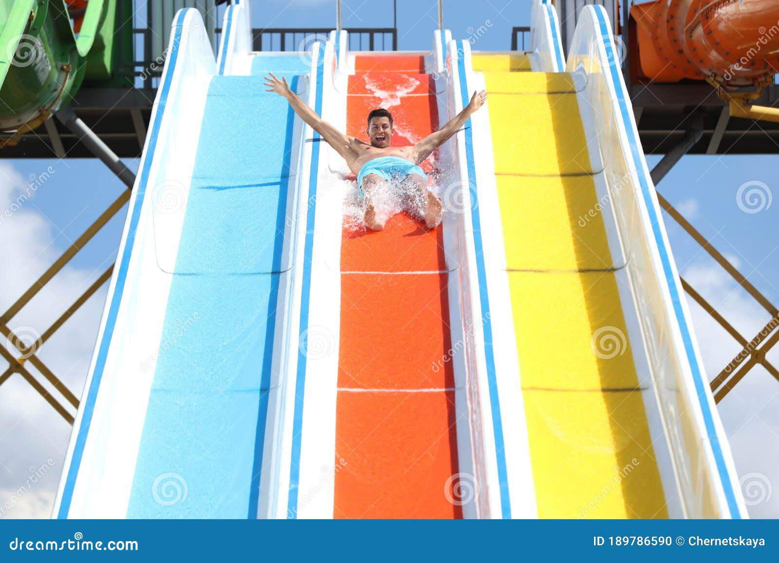 Man on Slide at Water Park. Summer Stock Photo - Image of blue ...