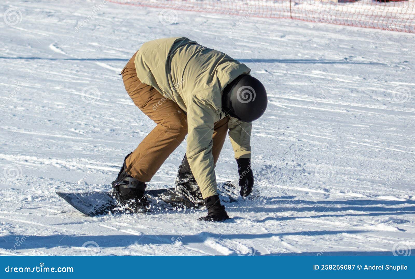 A Man Slides Down the Mountain on a Snowboard in the Snow. Stock Image ...