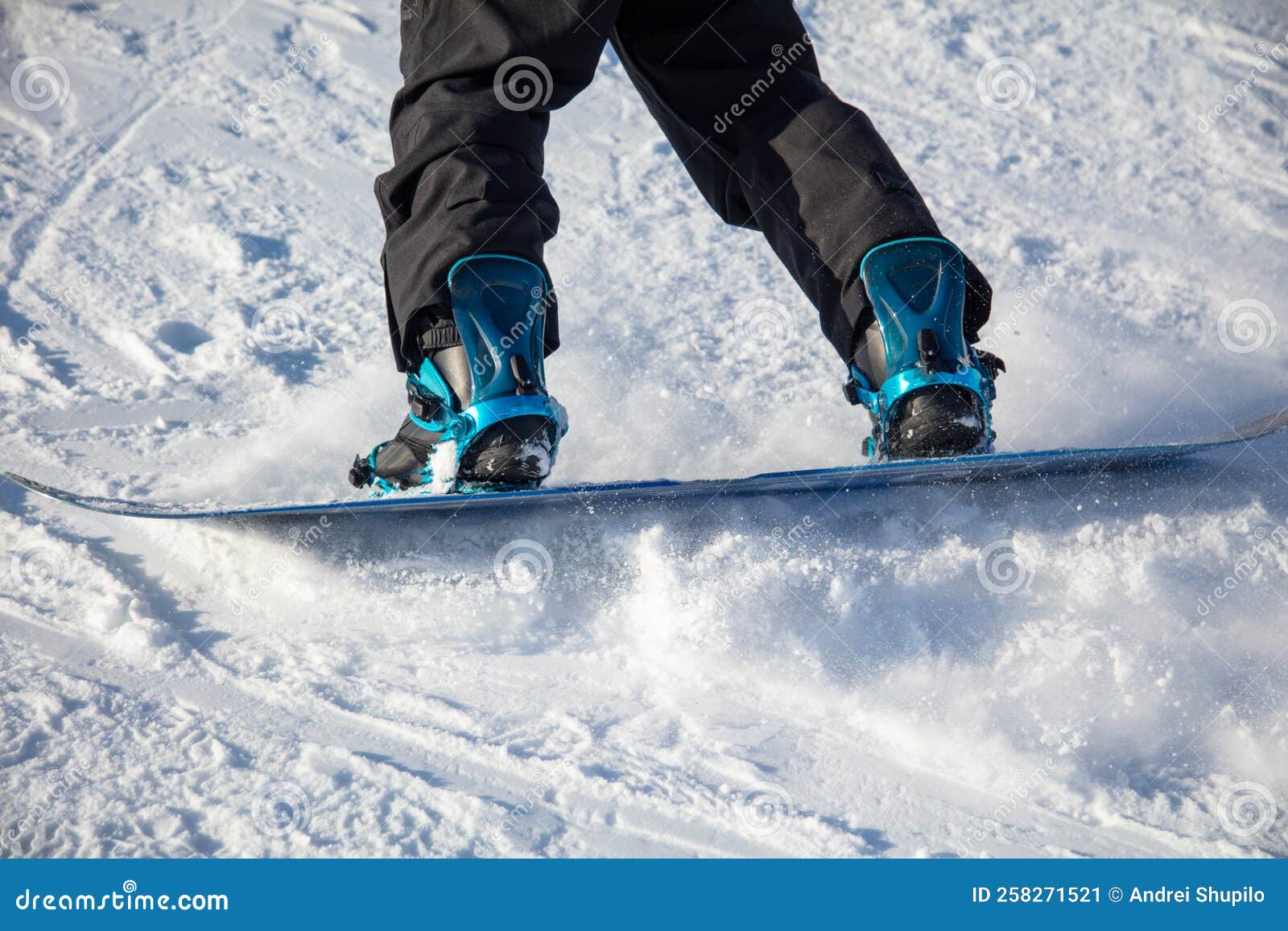 A Man Slides Down the Mountain on a Snowboard in the Snow. Stock Image ...