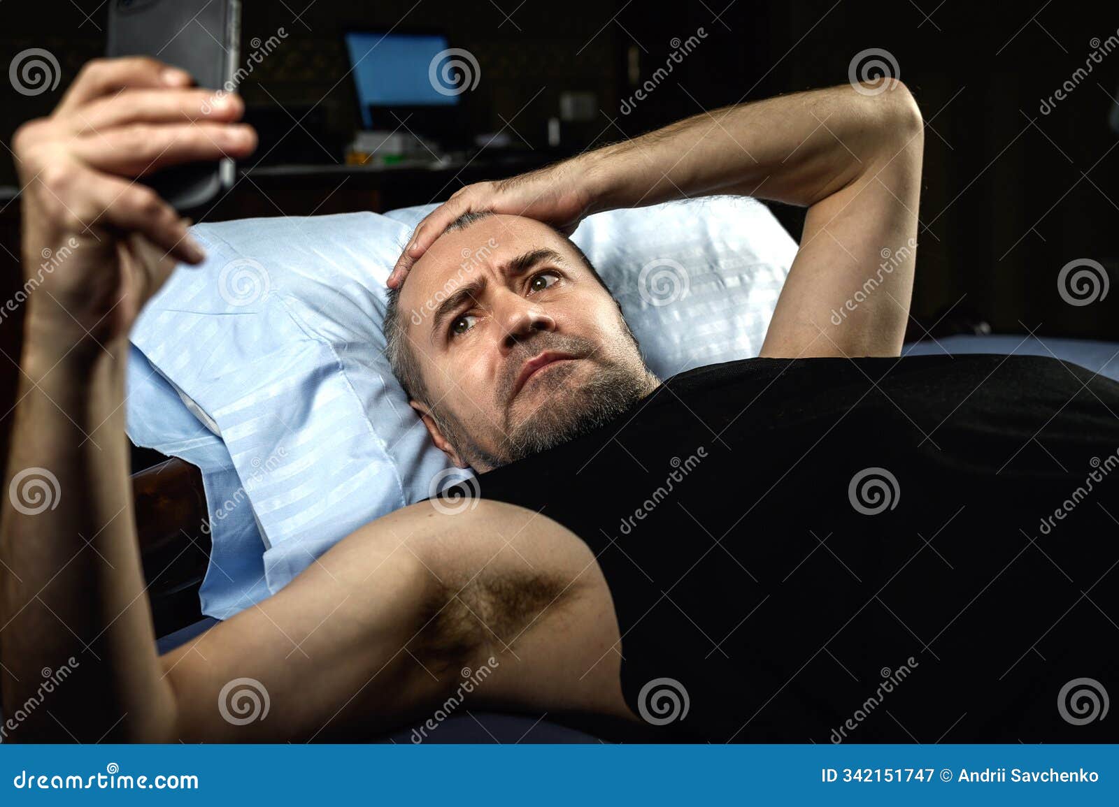 Handsome Man Using Clock In Bed After Waking Up In The Morning. Lazy ...