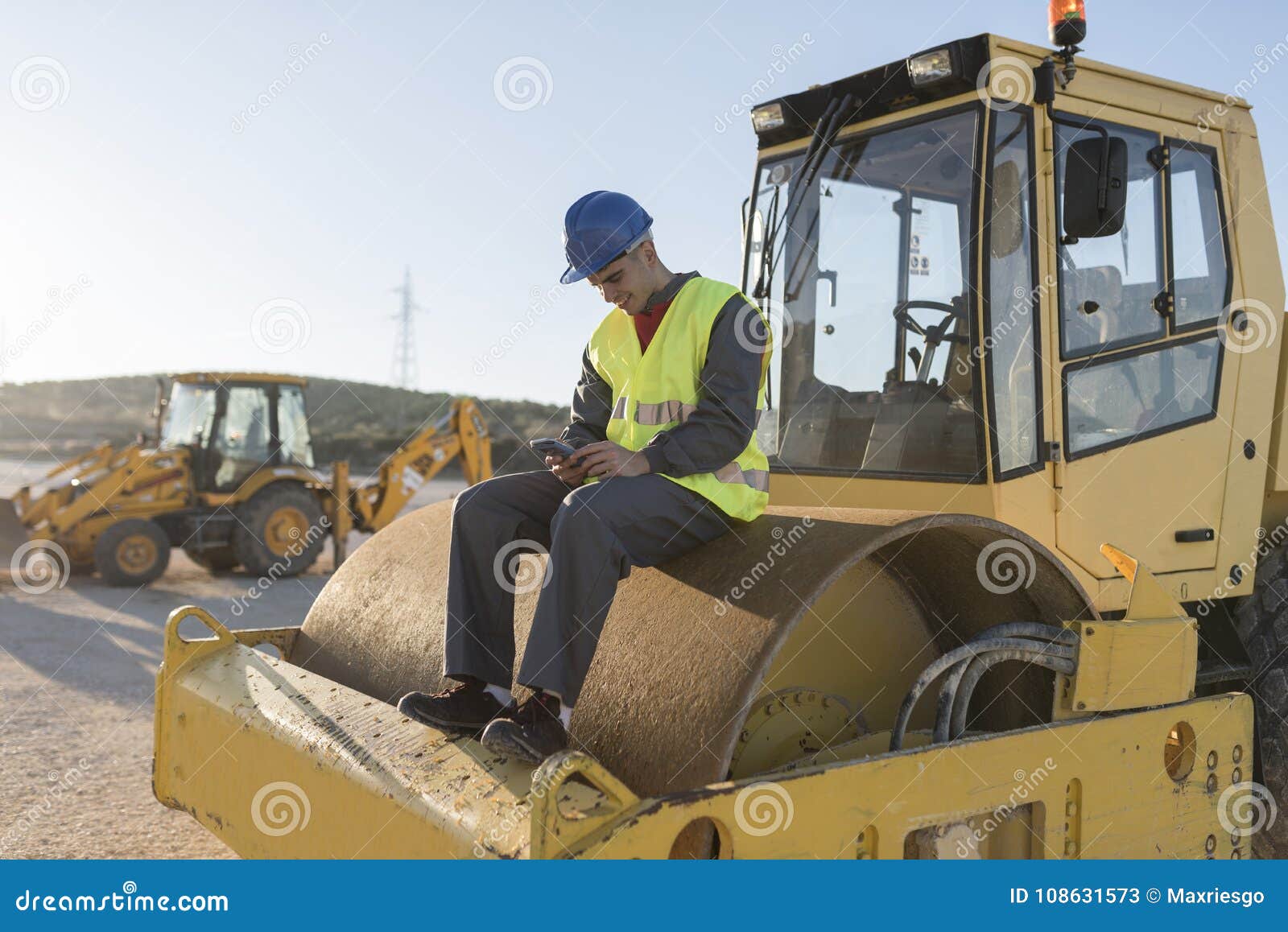 Man with Smartphone on Heavy Vehicle. Stock Image - Image of uniform ...