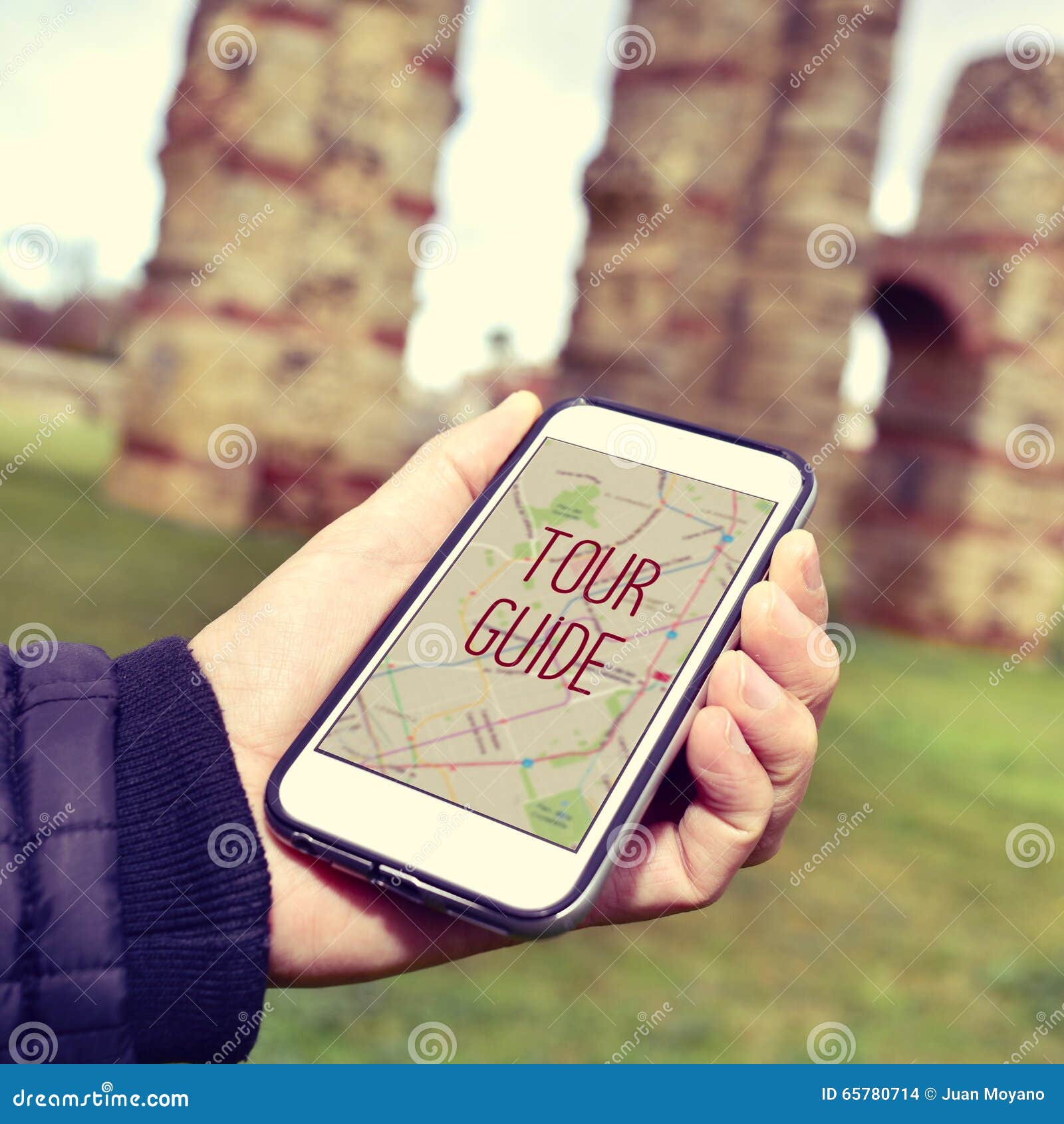 Man with a Smartphone with the Text Tour Guide Stock Photo - Image of ...
