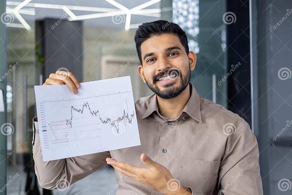 A Man with a Smile Presents Financial Data on a Chart in a Modern ...