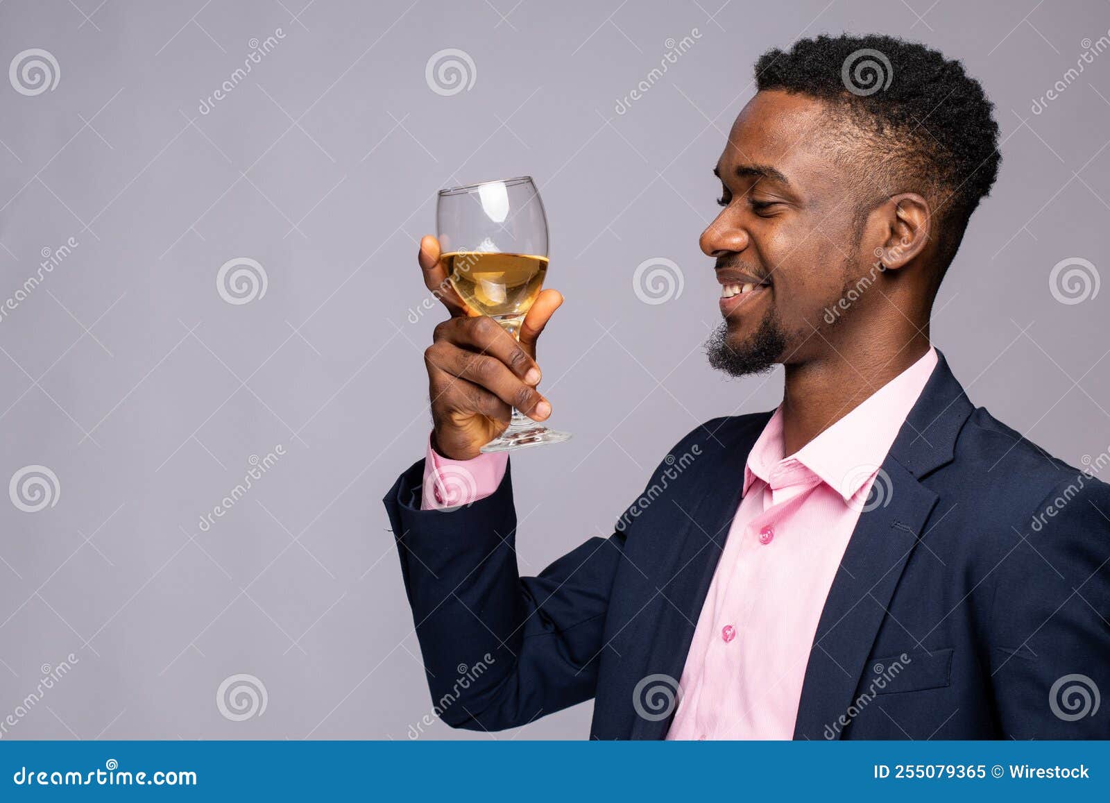 Man Smiles while Holding a Wine Glass Stock Image - Image of nigerian ...