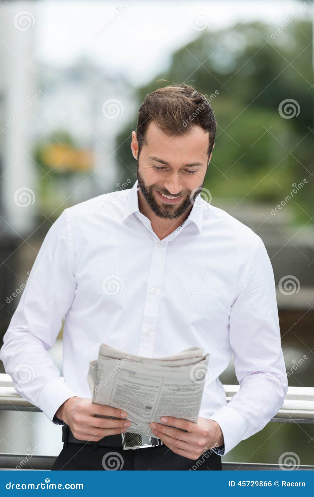 Man Smiling As he Reads the Newspaper Outdoors Stock Photo - Image of ...