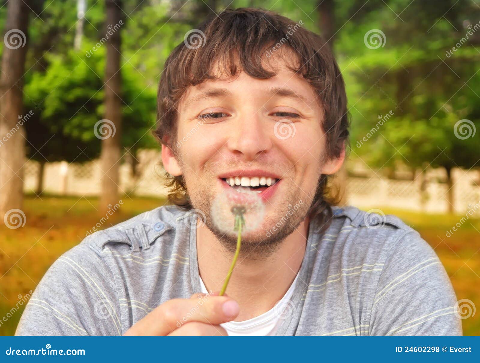 Man Smiling and Blowing Dandelion Stock Photo - Image of human ...