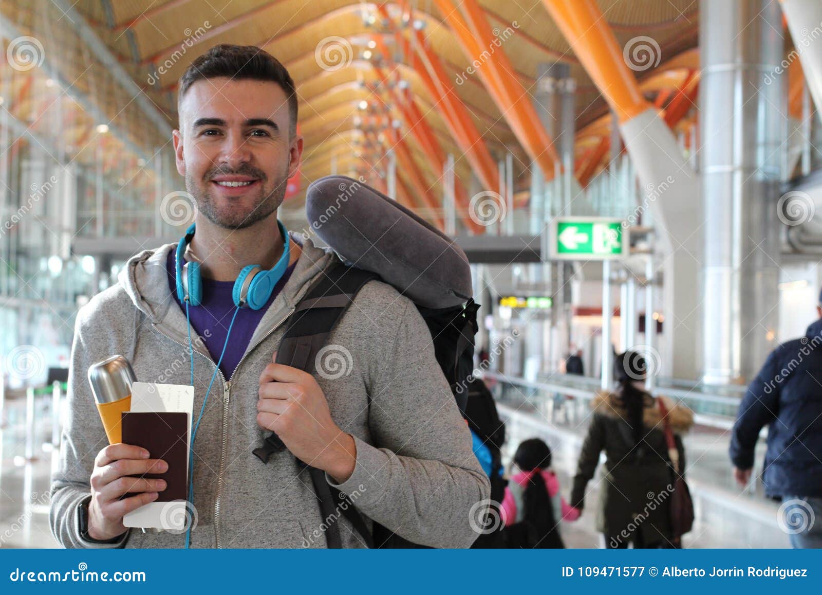 Man Smiling in Crowded Airport Stock Image - Image of crowd, baggage ...