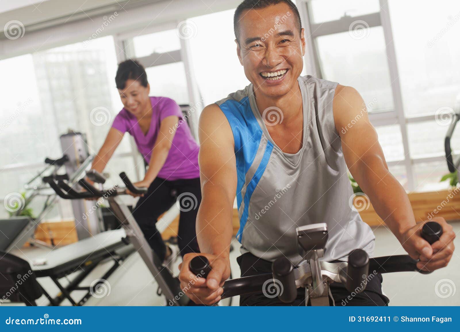 Man Smiling and Exercising on the Exercise Bike Stock Image - Image of ...