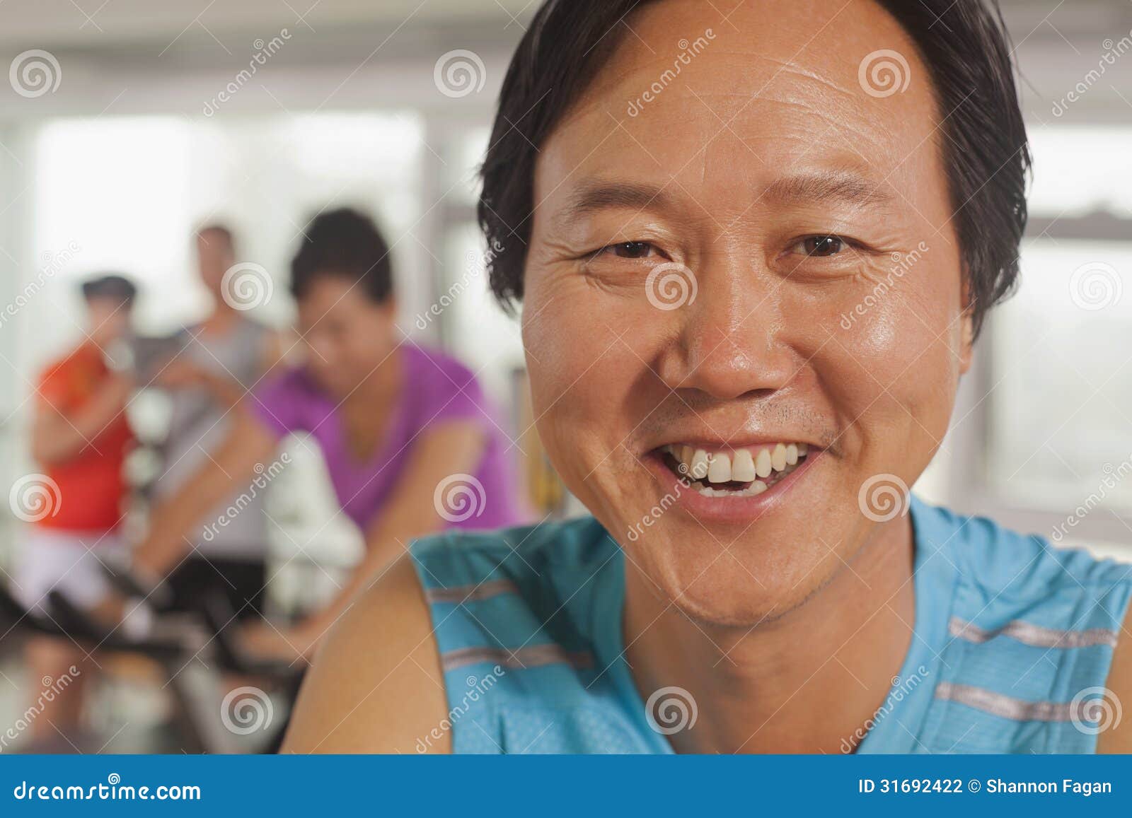Man Smiling and Exercising on the Exercise Bike Stock Photo - Image of ...