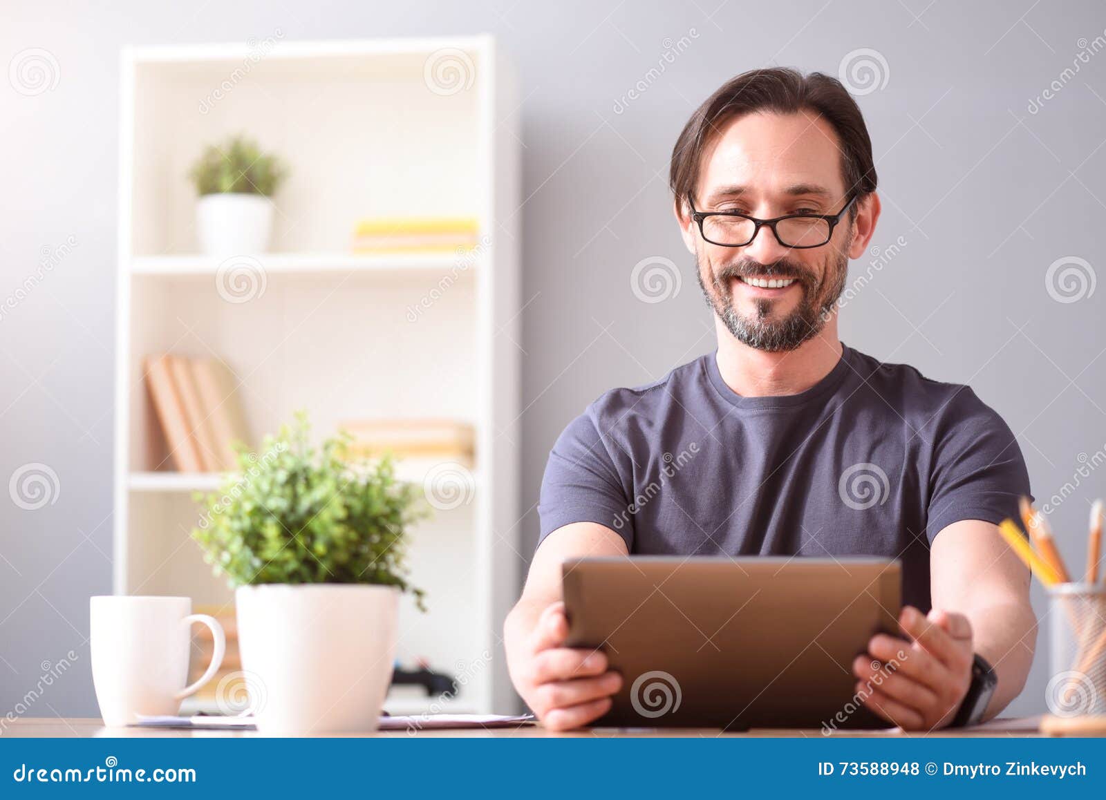 Man Smiling and Looking at Tablet Stock Photo - Image of conversation ...