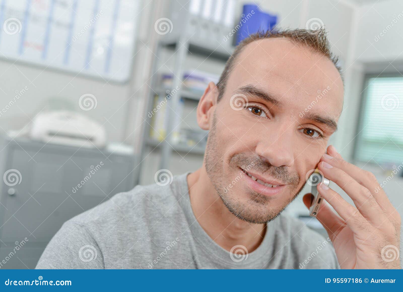 Man smiling while on phone stock photo. Image of indoors - 95597186