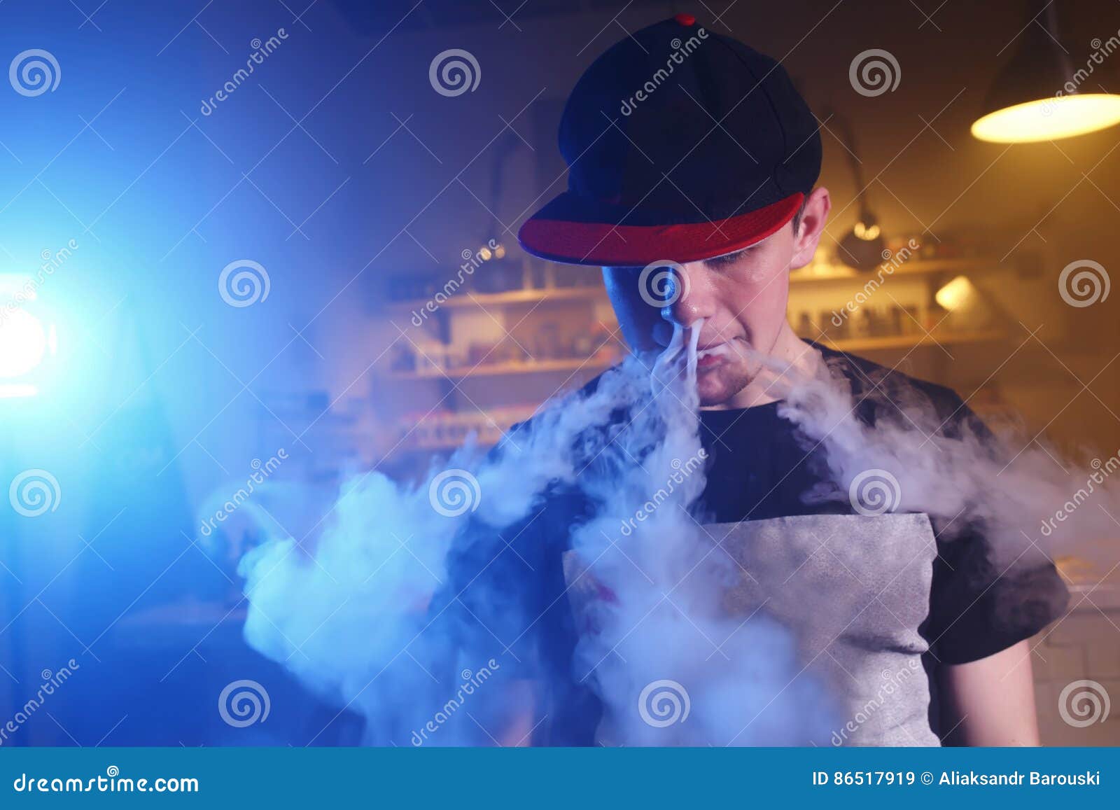 The Man Smoke an Electronic Cigarette at the Vape Shop Stock Image ...