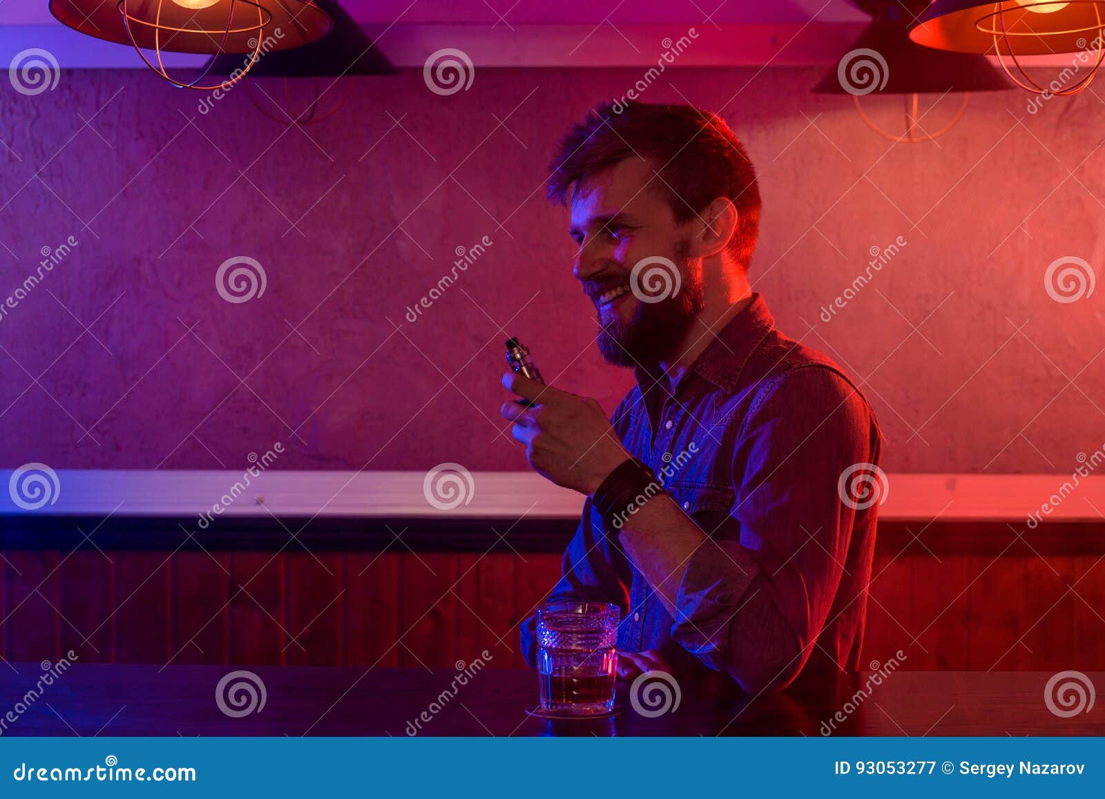 The Man Smoke an Electronic Cigarette at the Vape Shop. Stock Image ...