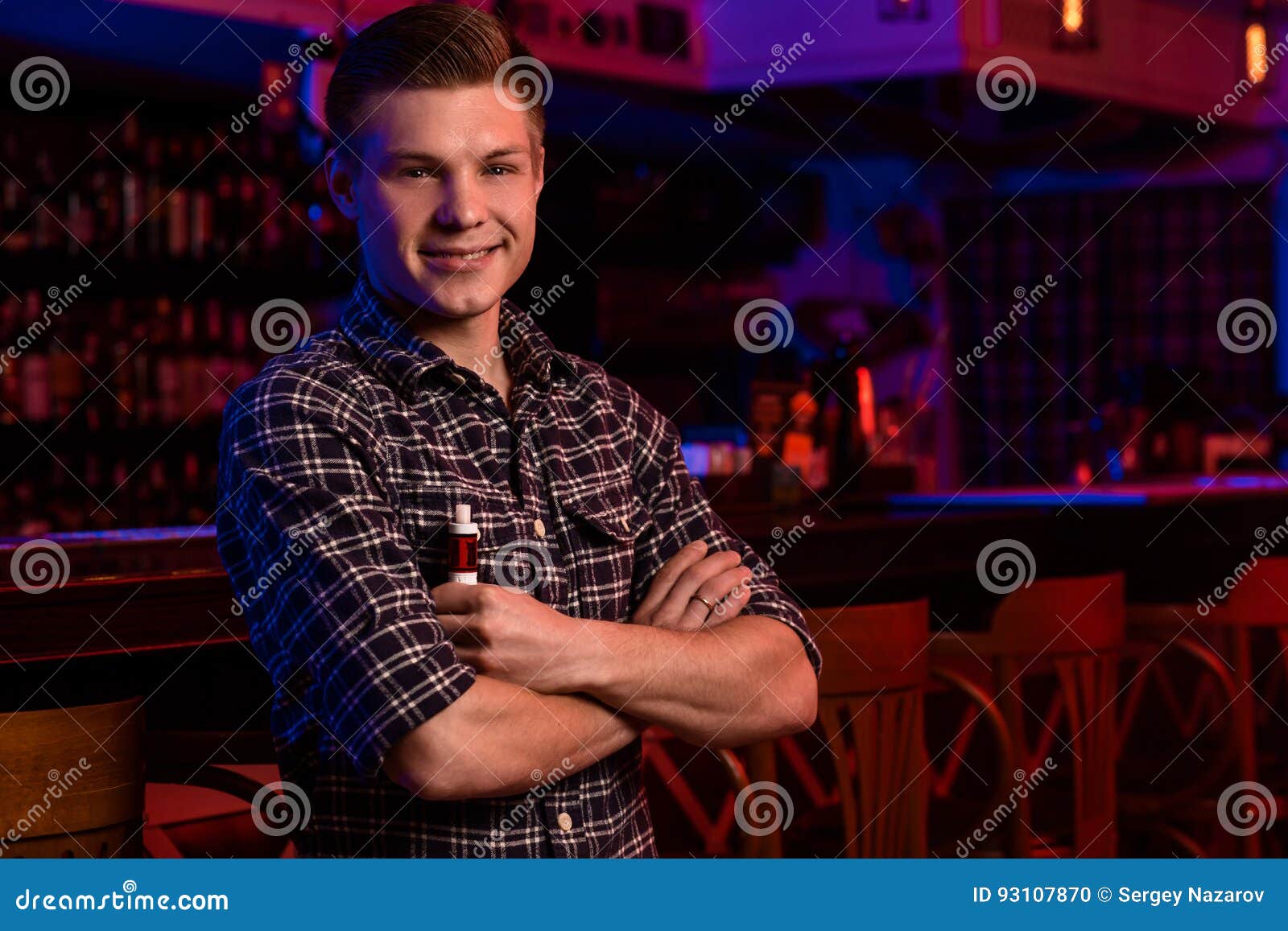 The Man Smoke an Electronic Cigarette at the Vape Shop. Stock Photo ...