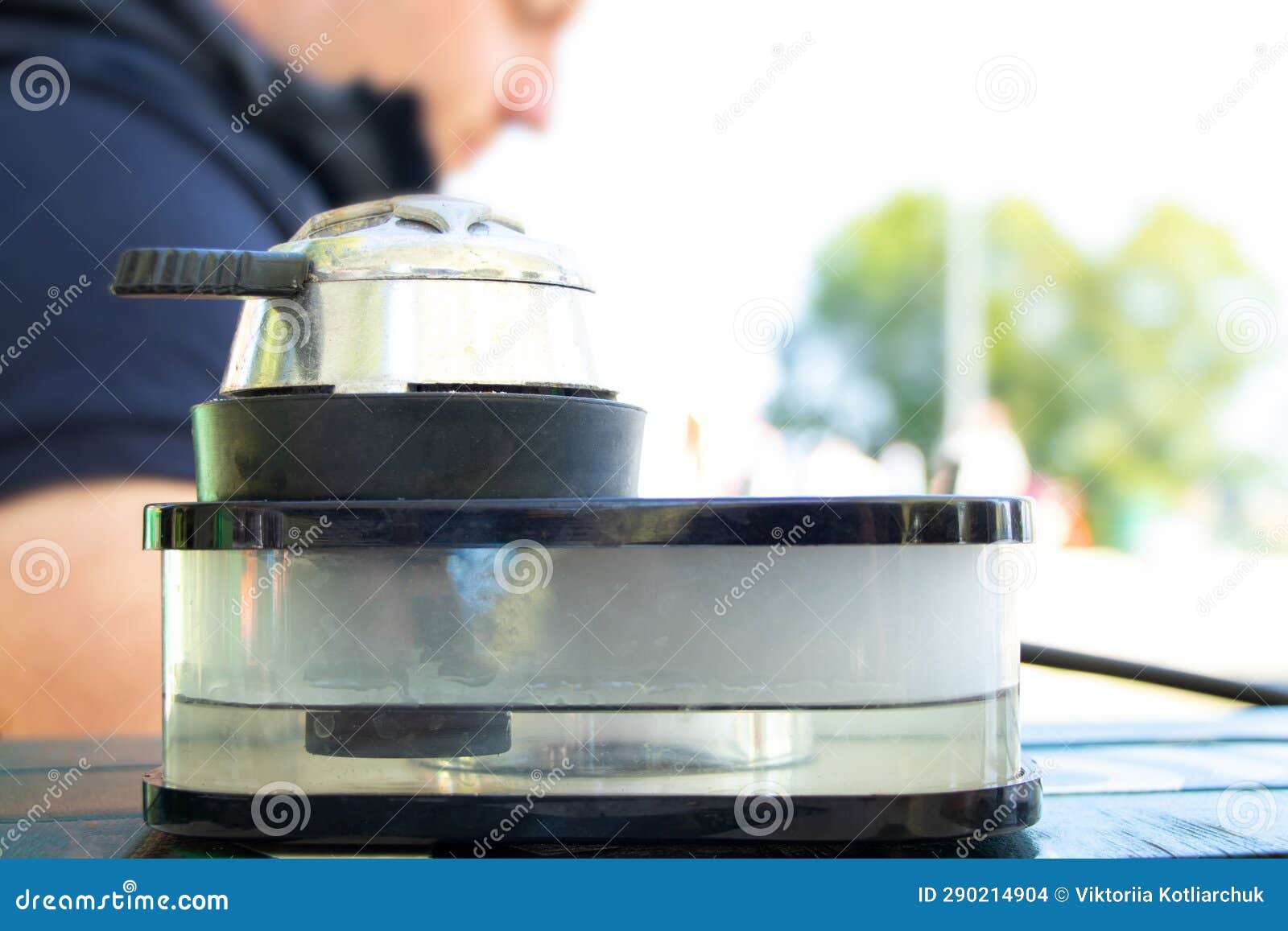 A Man Smokes a Hookah on a Mountain in Bukovel in the Summer in the Sun ...