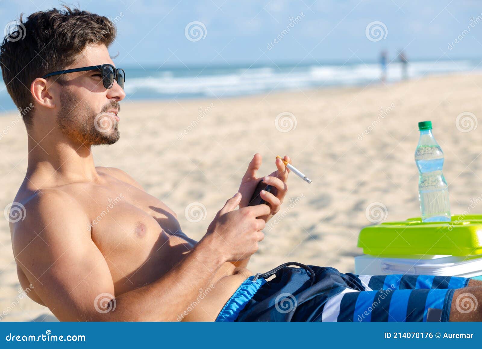 Man smoking at beach stock photo. Image of blue, people - 214070176
