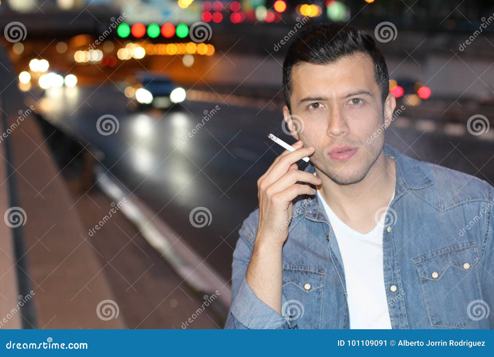 Man Smoking a Cigarette in the City Streets at Night Stock Image ...