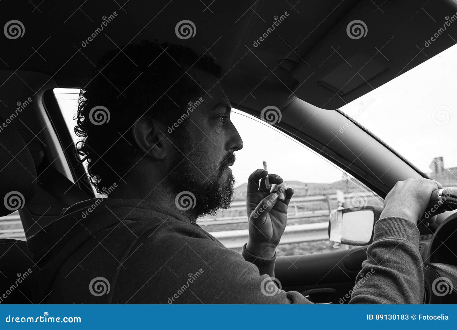 Man smoking driving stock image. Image of addiction, move - 89130183