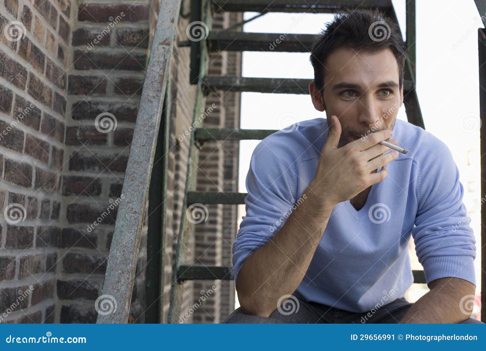 Man Smoking on Steps stock image. Image of clothing, horizontal - 29656991