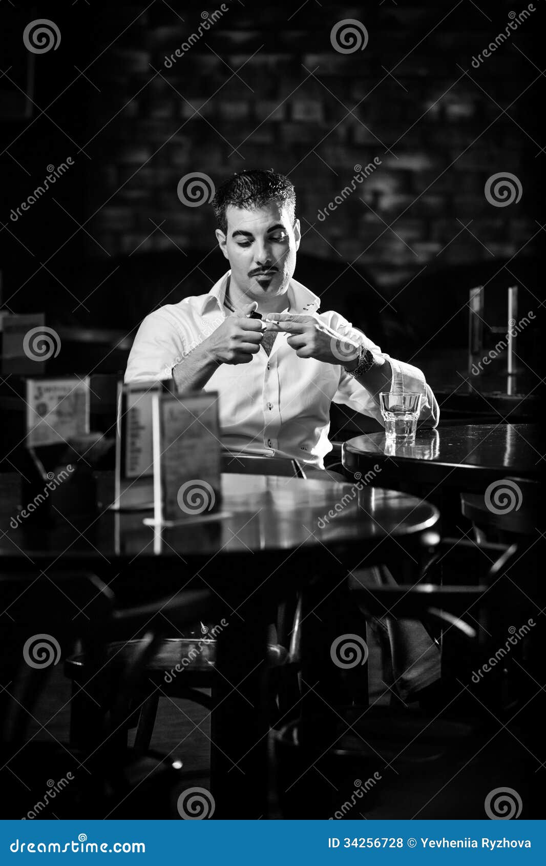 Man smoking at the table stock photo. Image of glamour - 34256728