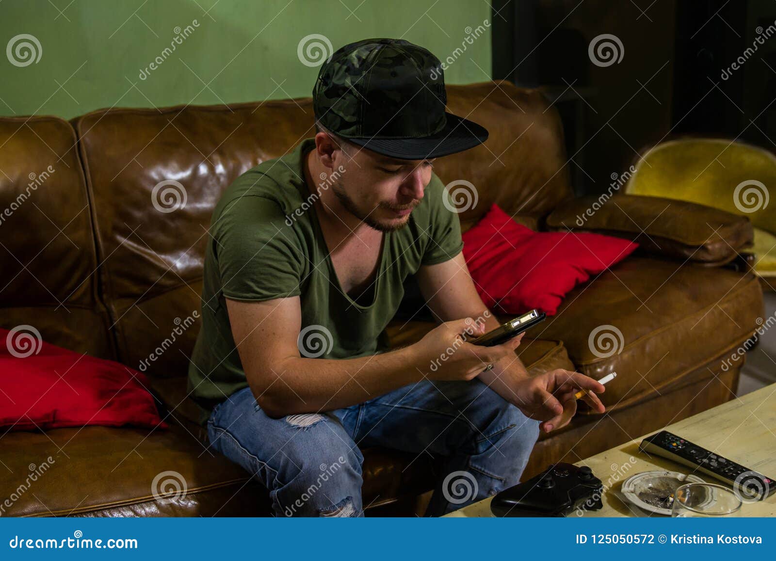 A Man is Smoking and Talking on the Phone Stock Photo - Image of ...
