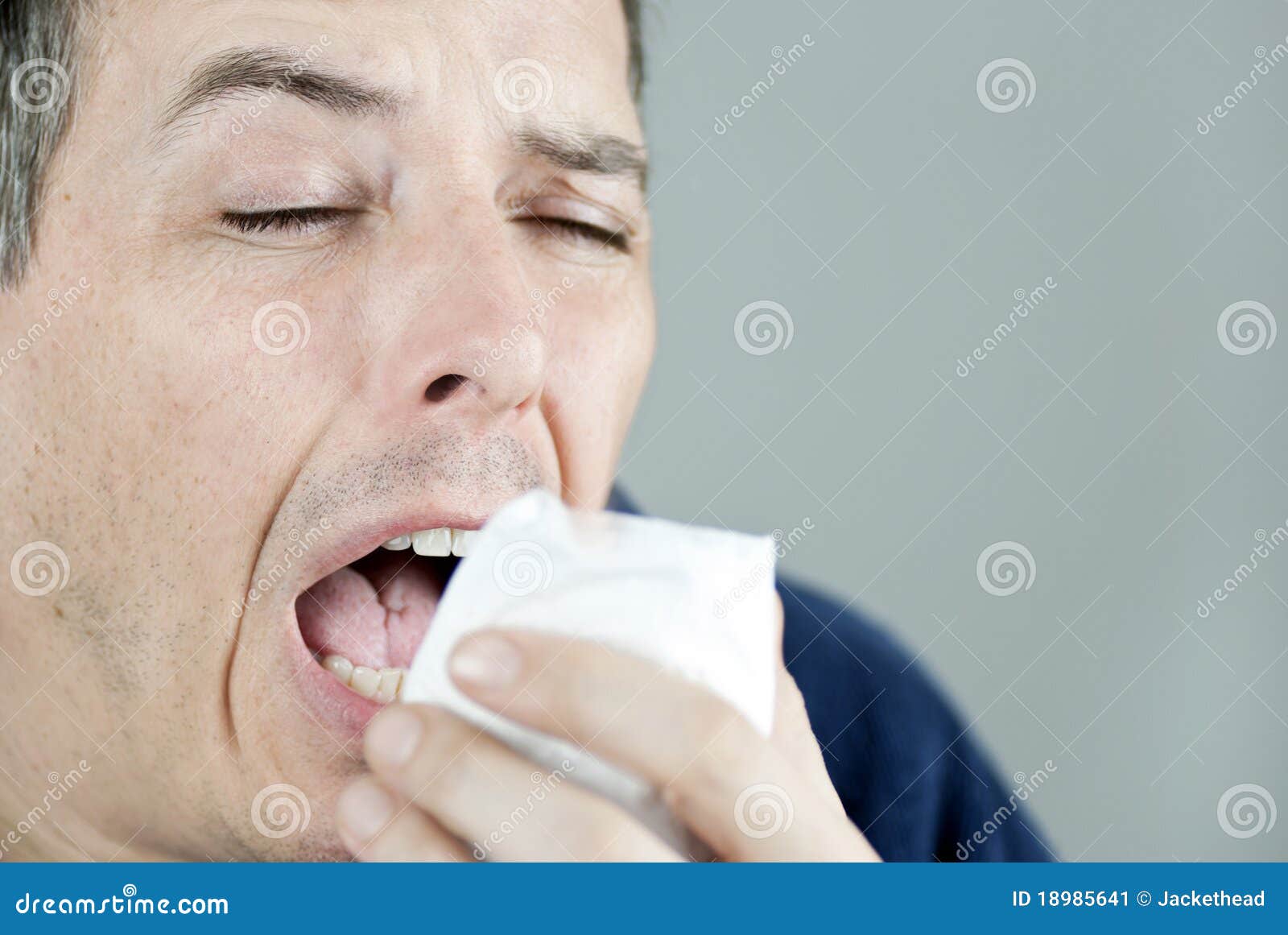 Man Sneezing into Tissue stock image. Image of handkerchief - 18985641