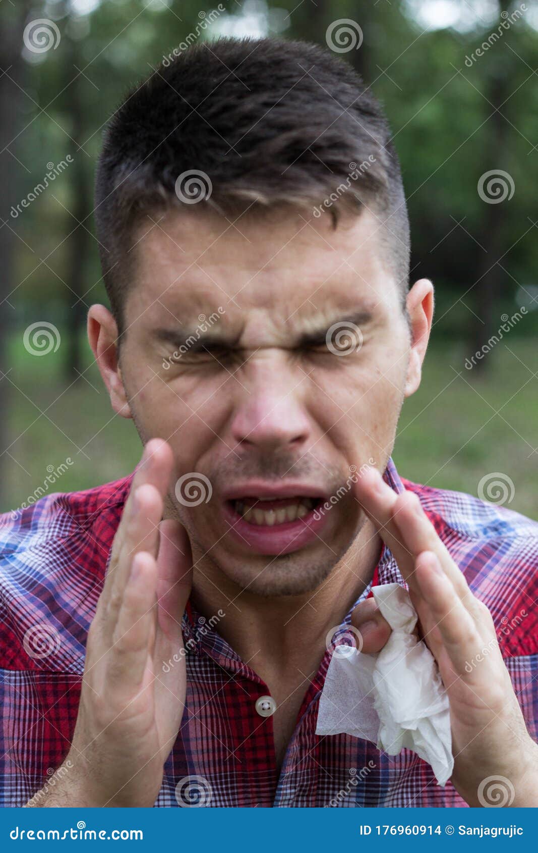Man Sneezing into Tissue. Handsome Man Blowing His Nose in the Park ...