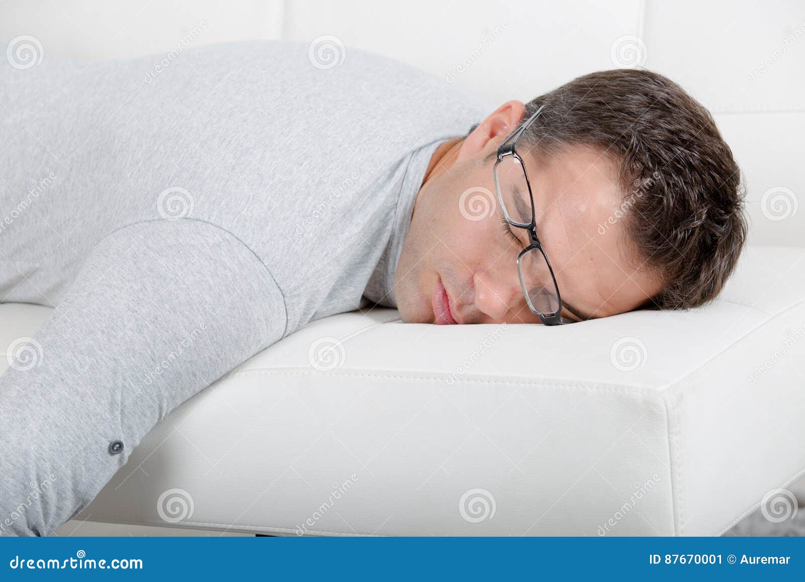 Man snoozing on sofa stock image. Image of single, expression - 87670001