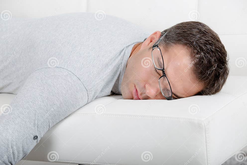 Man snoozing on sofa stock image. Image of single, expression - 87670001