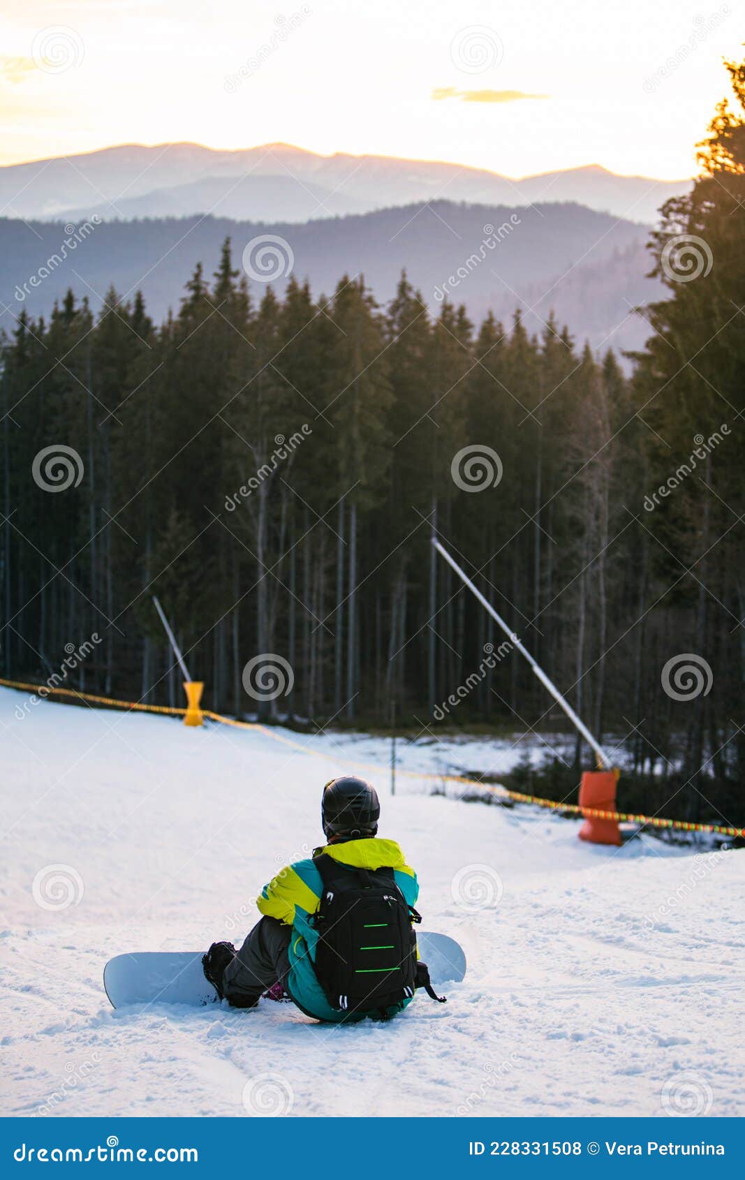 Man with Snowboard Sitting at Slope Enjoying the View Stock Photo ...