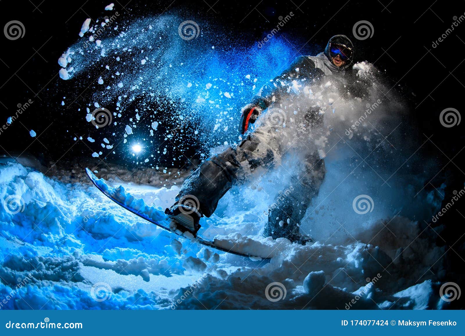 Man Snowboarder Doing Stunts on Blue Light Background Stock Photo ...