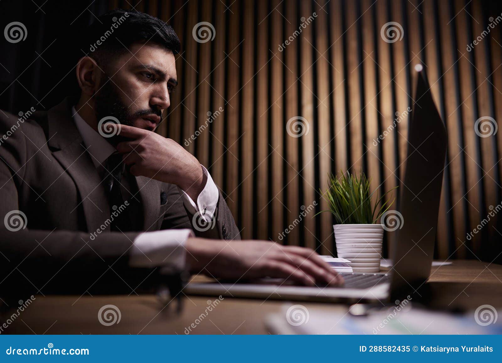A Man of Spanish Appearance Works at the Office with a Laptop Stock ...