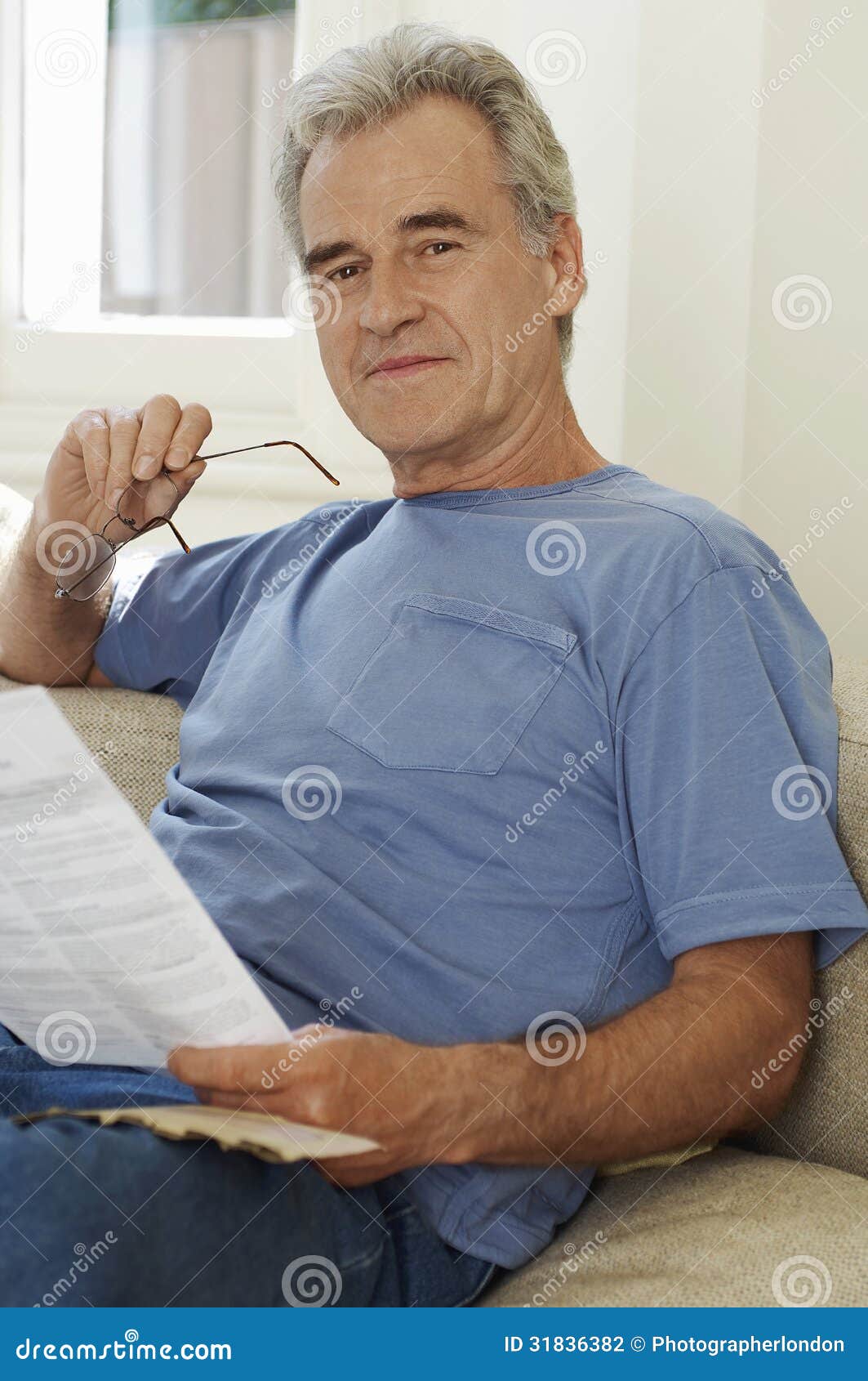 Man with Spectacles and Bill Sitting on Sofa Stock Photo - Image of ...