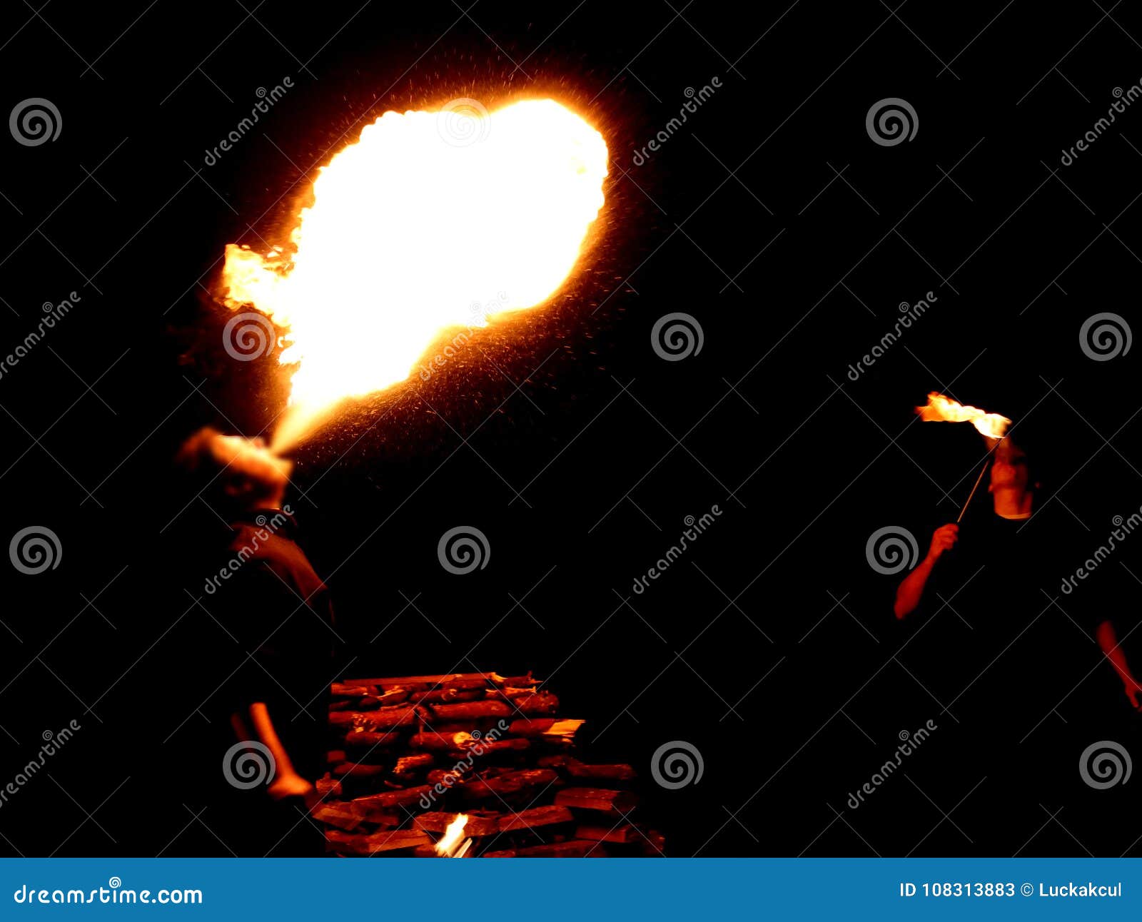 Fire Show.the Man is Spitting Fire and Ignites the Bonfire. Stock Image ...