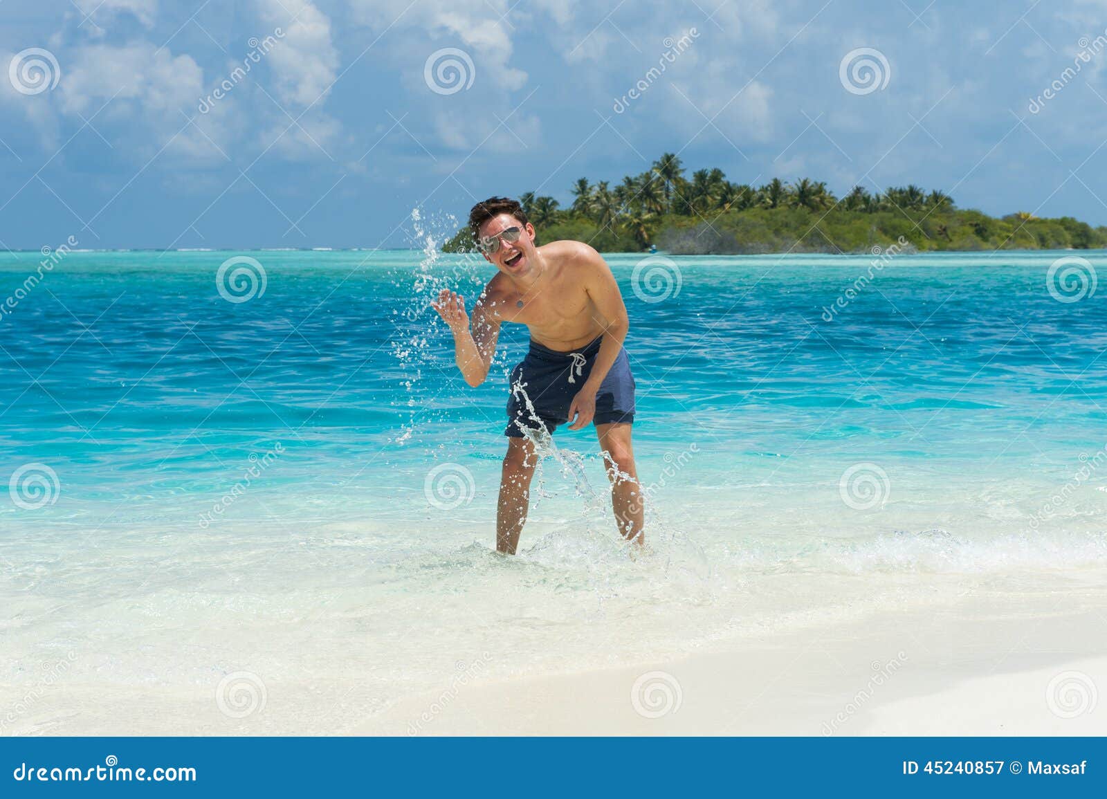 Man Splash Water of the Ocean at the Background of Island Stock Image ...
