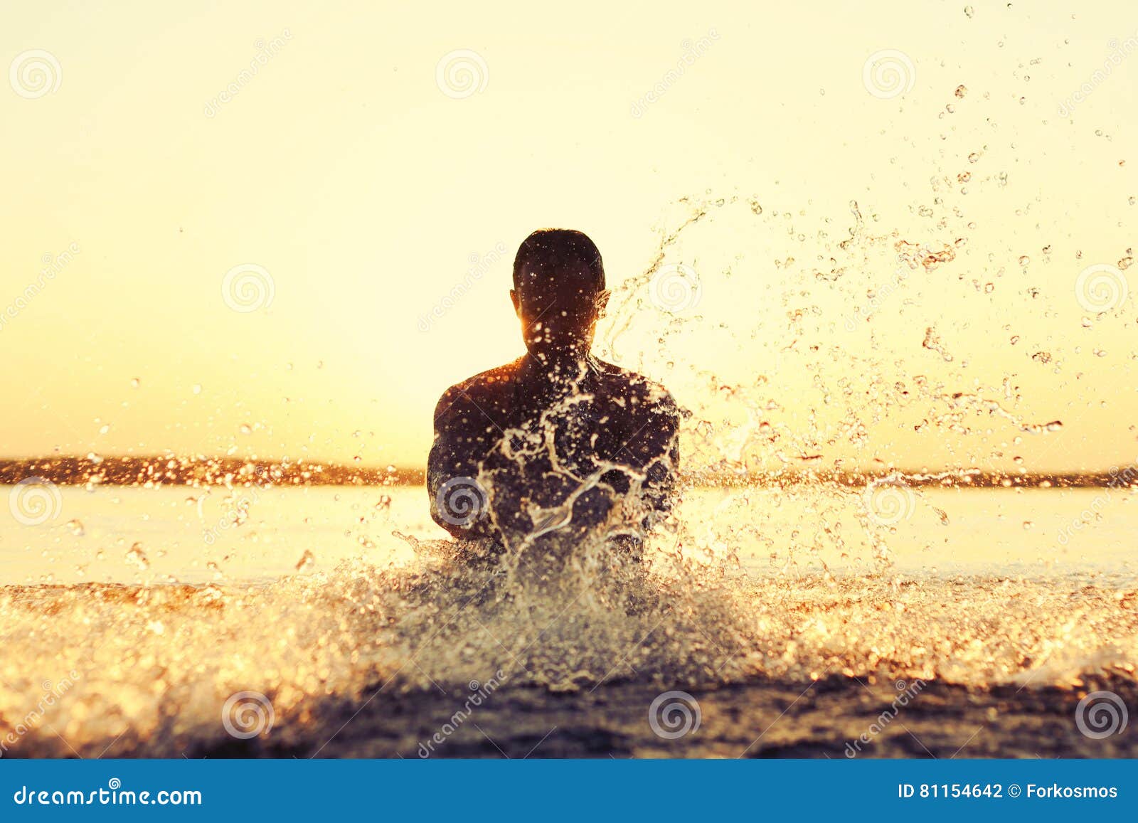 Man Splashing in the Water at Sunset Stock Photo - Image of healthy ...