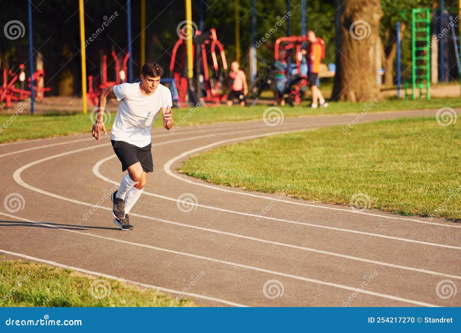 Man in Sportive Unifrom Running on the Track at Daytime Stock Photo ...