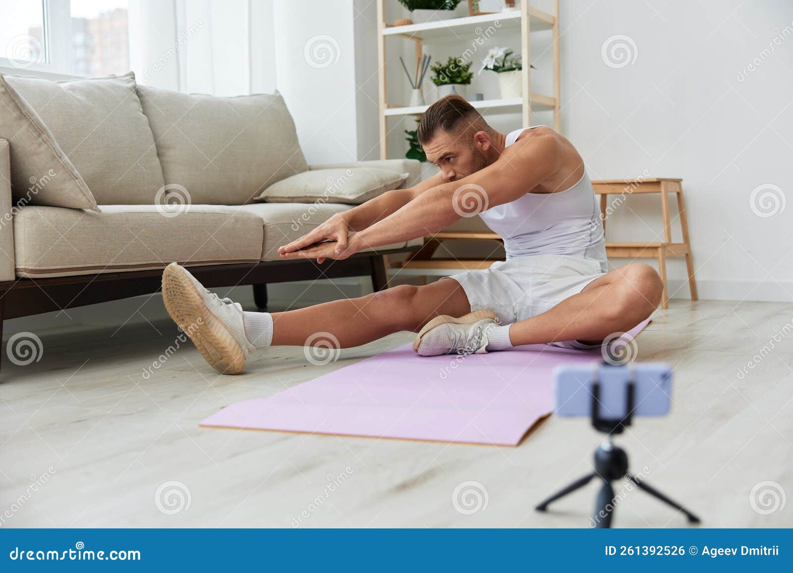 Man Sports Watching A Workout Tape On His Phone And Repeating