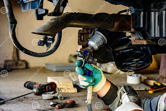Man Spraying an Anti-corrosion Compound on Bottom of Car. Stock Photo ... Man Spraying an Anti-corrosion Compound on Bottom of Car. Stock Photo ...