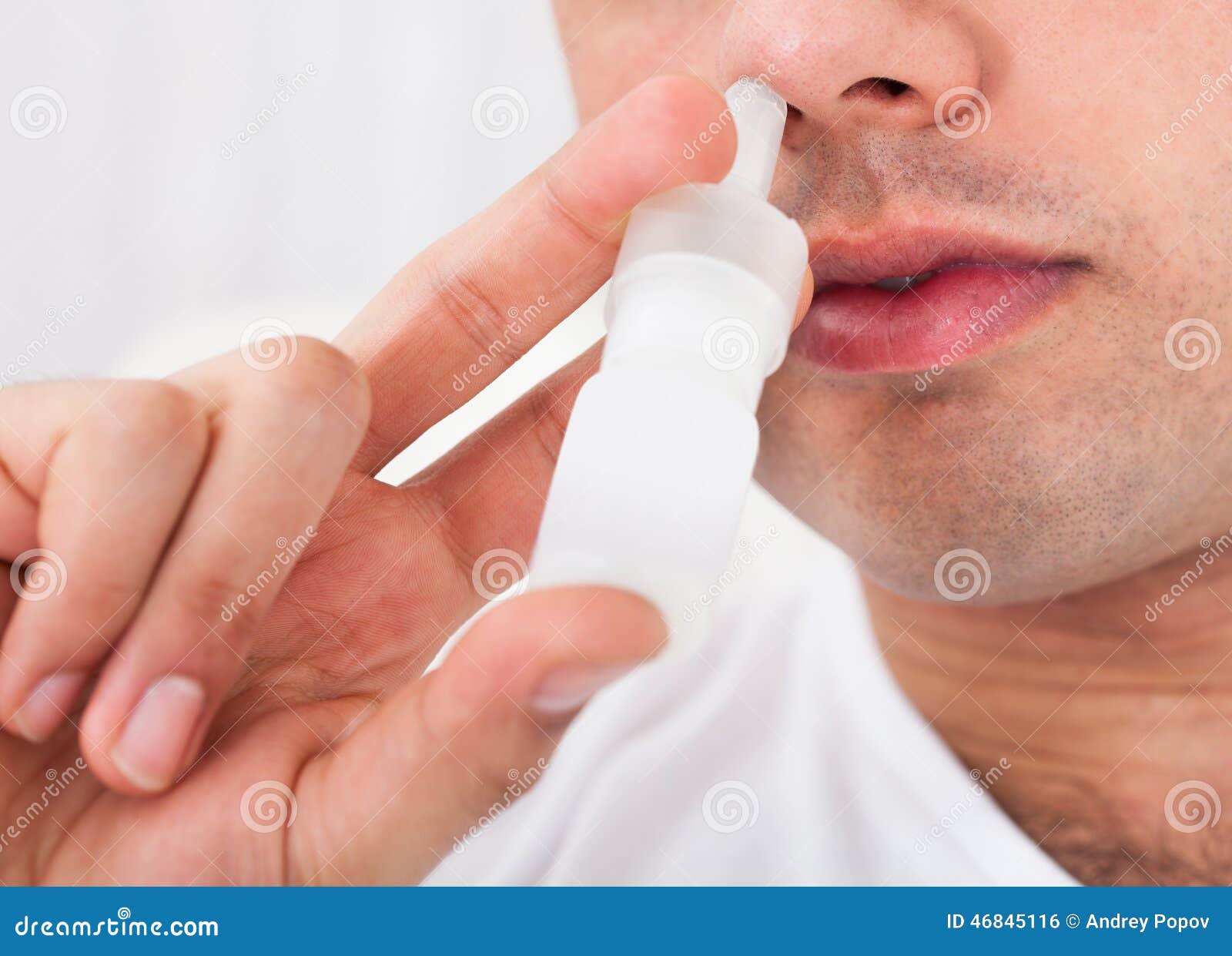 Man spraying drops in nose stock photo. Image of face - 46845116