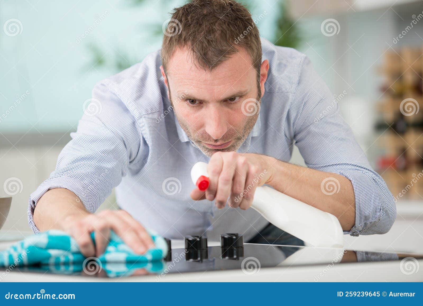 Man spraying at home stock image. Image of routine, holding - 259239645