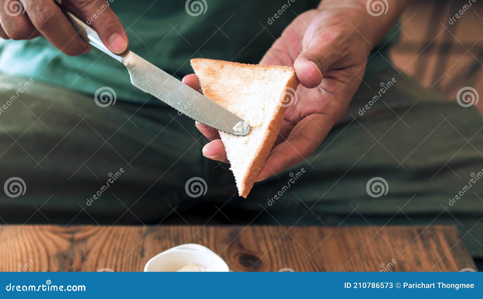 Man Spreading Butter on the Bread with Pan Fried Egg with Toppings ...